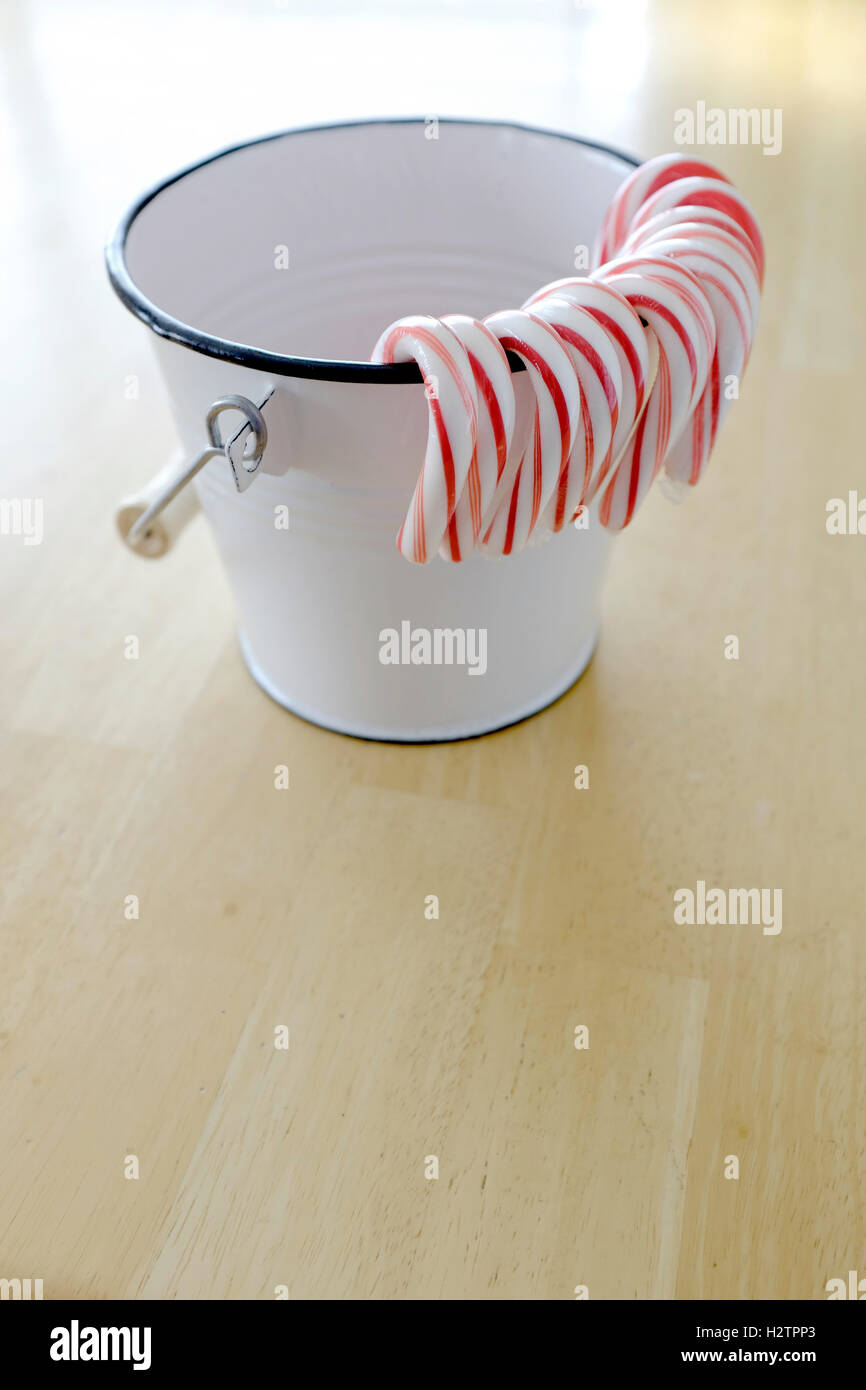 Closeup of isolated candy canes in a white bucket Stock Photo - Alamy