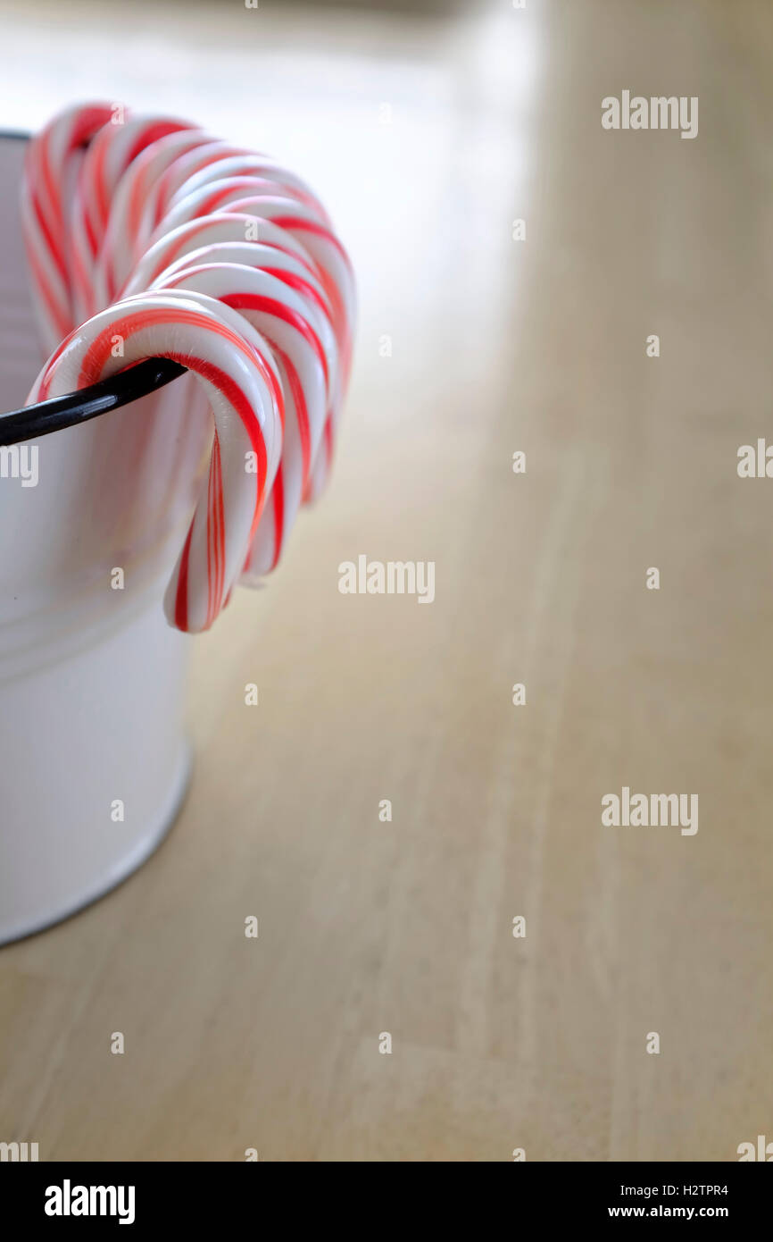 Closeup of isolated candy canes in a white bucket Stock Photo - Alamy
