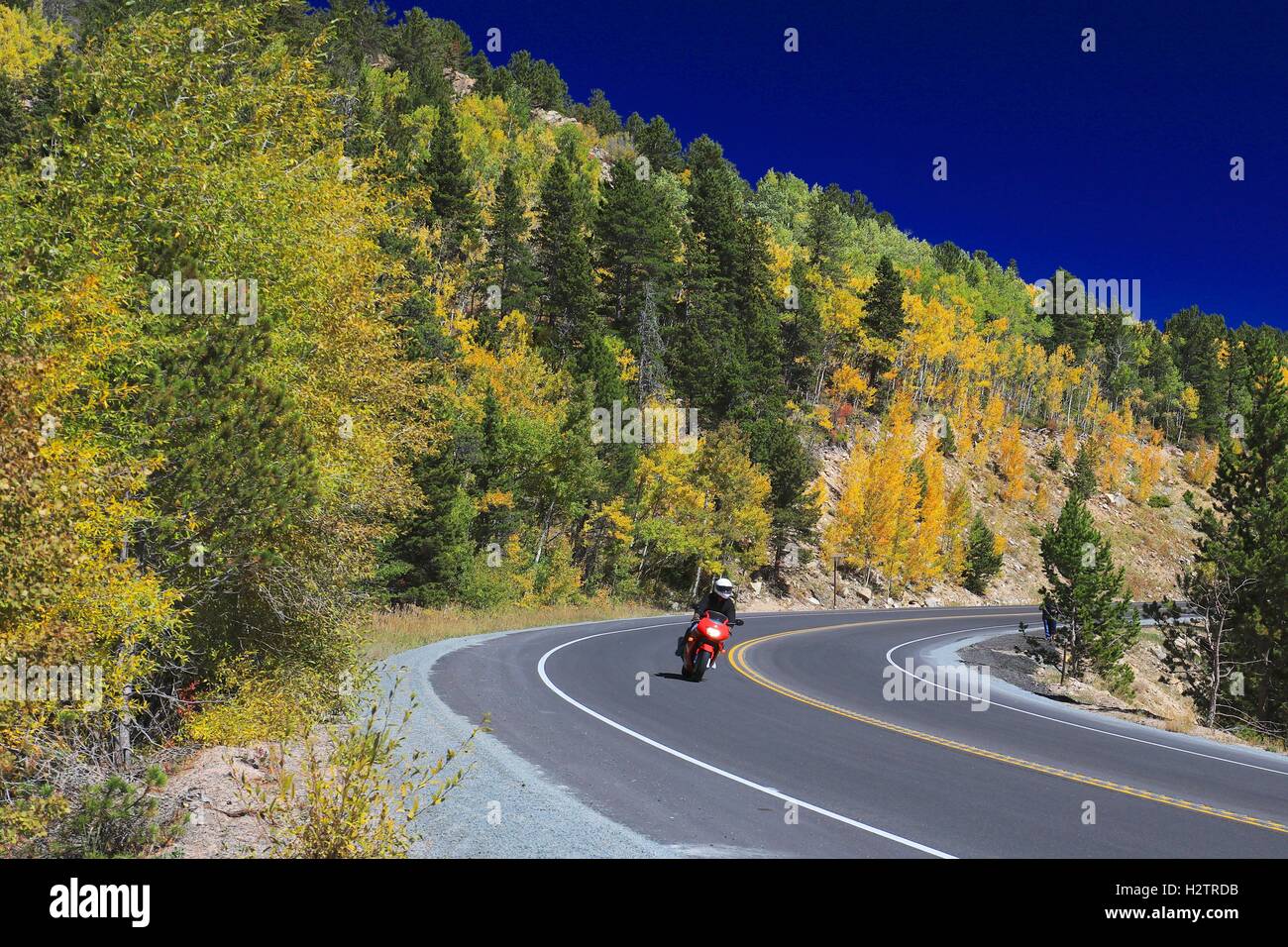 Motorcycle on mountain highway curve with autumn and fall colors Stock ...