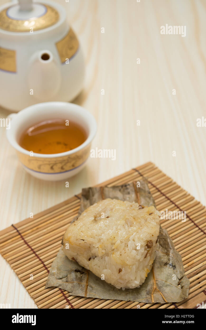 traditional Chinese glutinous rice dumpling with cup of tea and teapot ...
