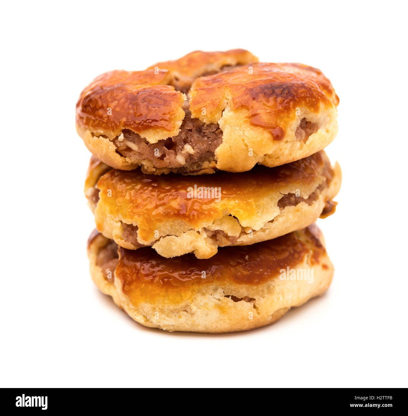 side view sweet mini chewy cakes or chickee cakes stacked up on white ...