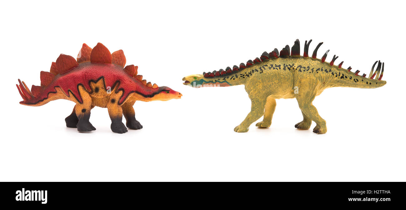 yellow huayangosaurus and red stegosaurus toys on a white background ...
