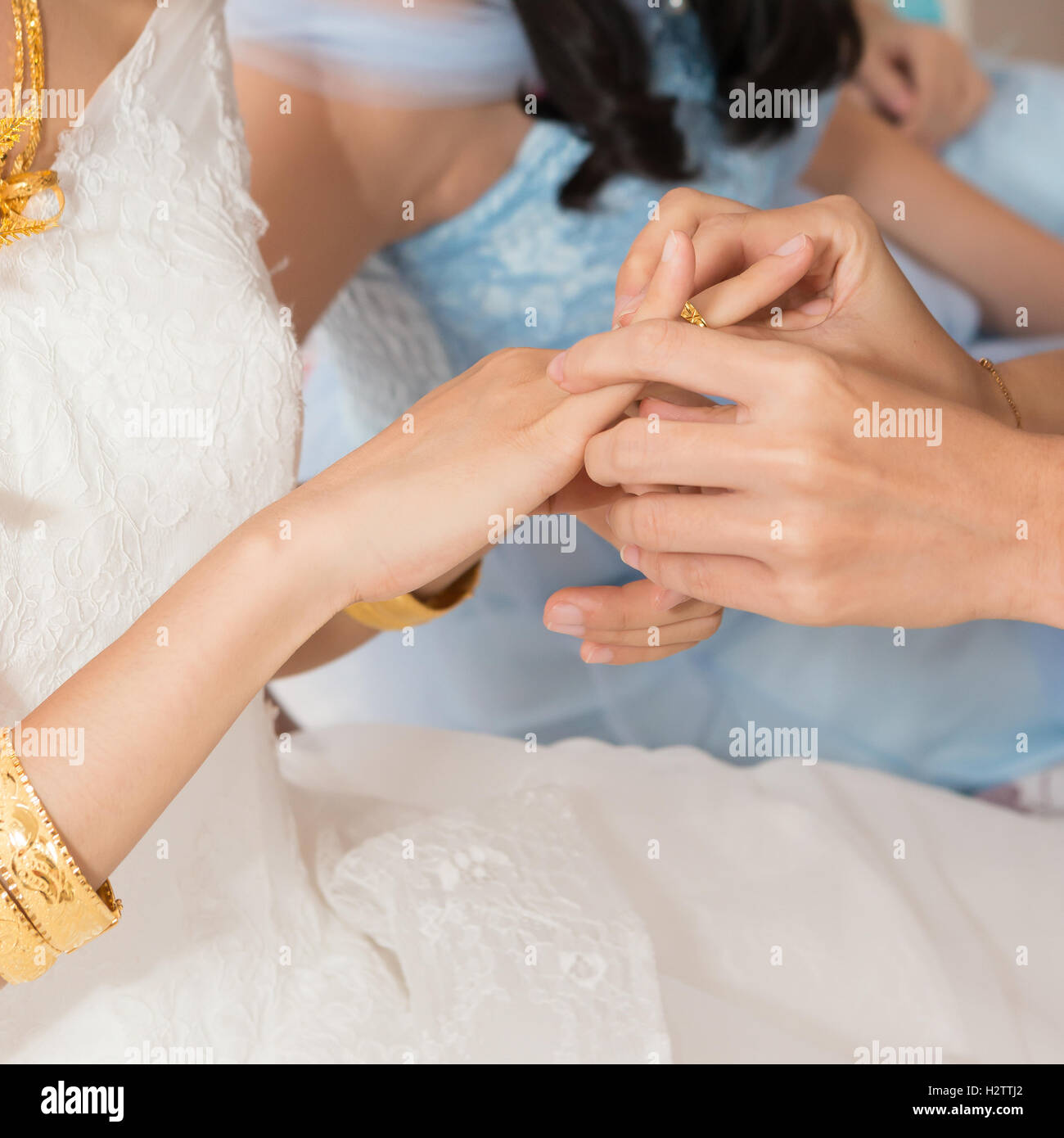 friends helping the bride wearing a gold wedding ring Stock Photo - Alamy