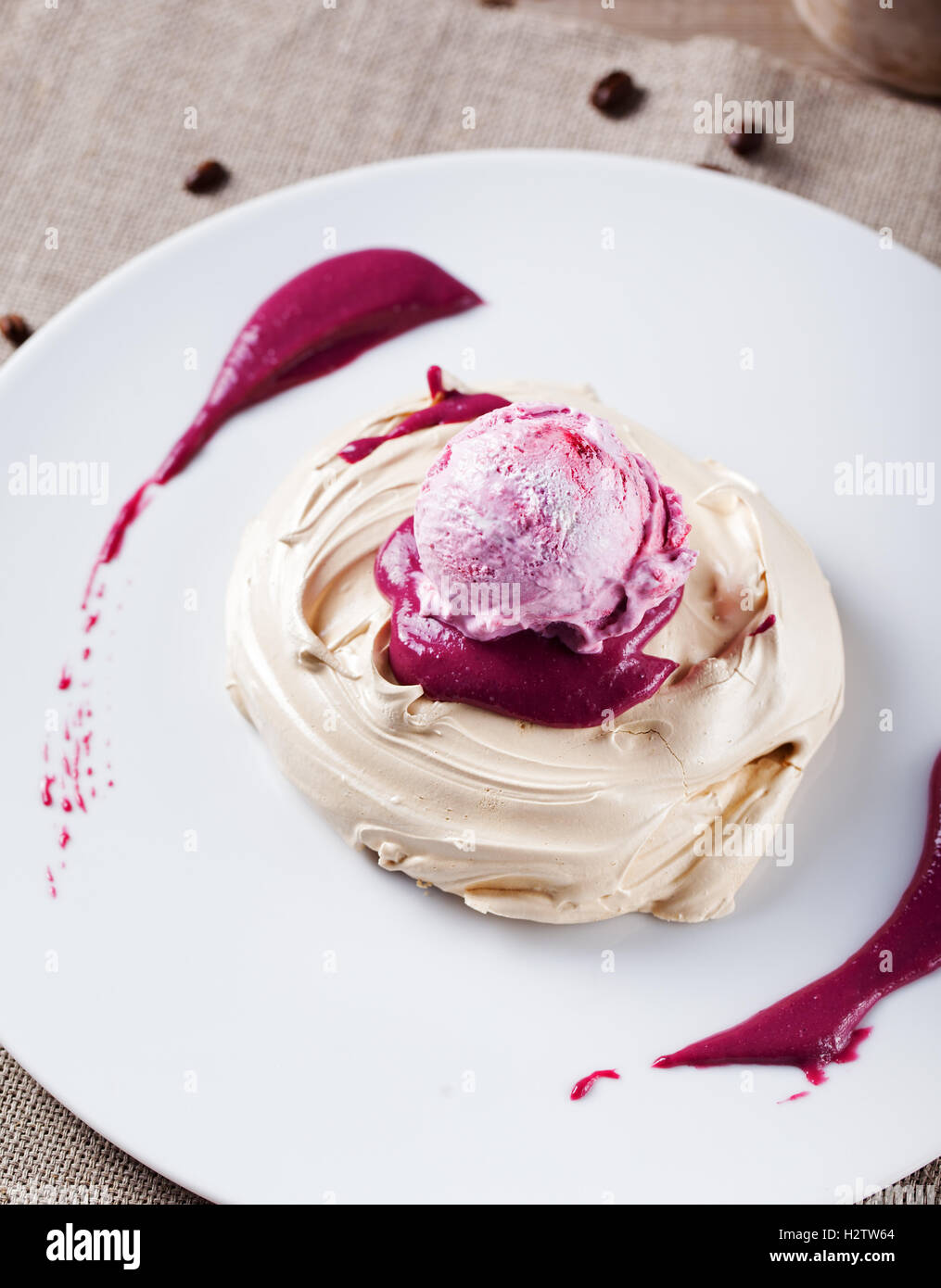 Meringue with berry ice cream on a white plate Stock Photo - Alamy