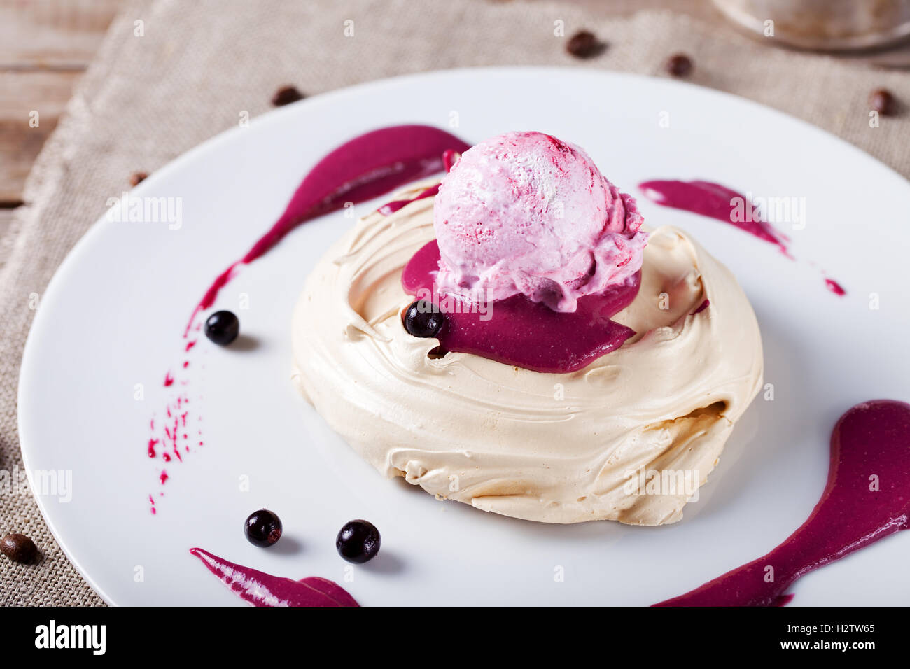 Meringue with berry ice cream on a white plate Stock Photo - Alamy