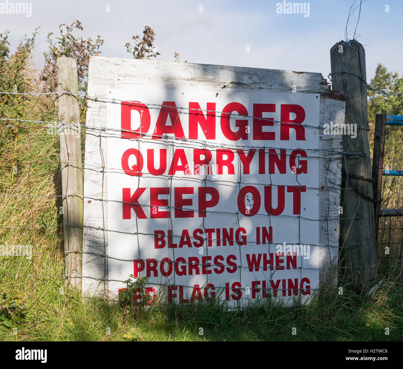 A danger blasting in progress sign above a working quarry in Frosterley ...