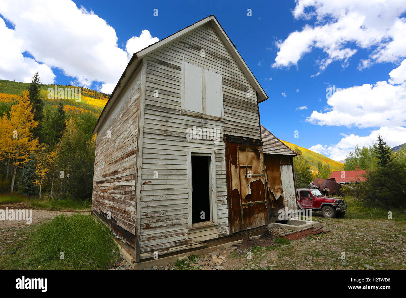 Colorado Historic Ghost Town cabin with jeep and autumn colors Stock ...