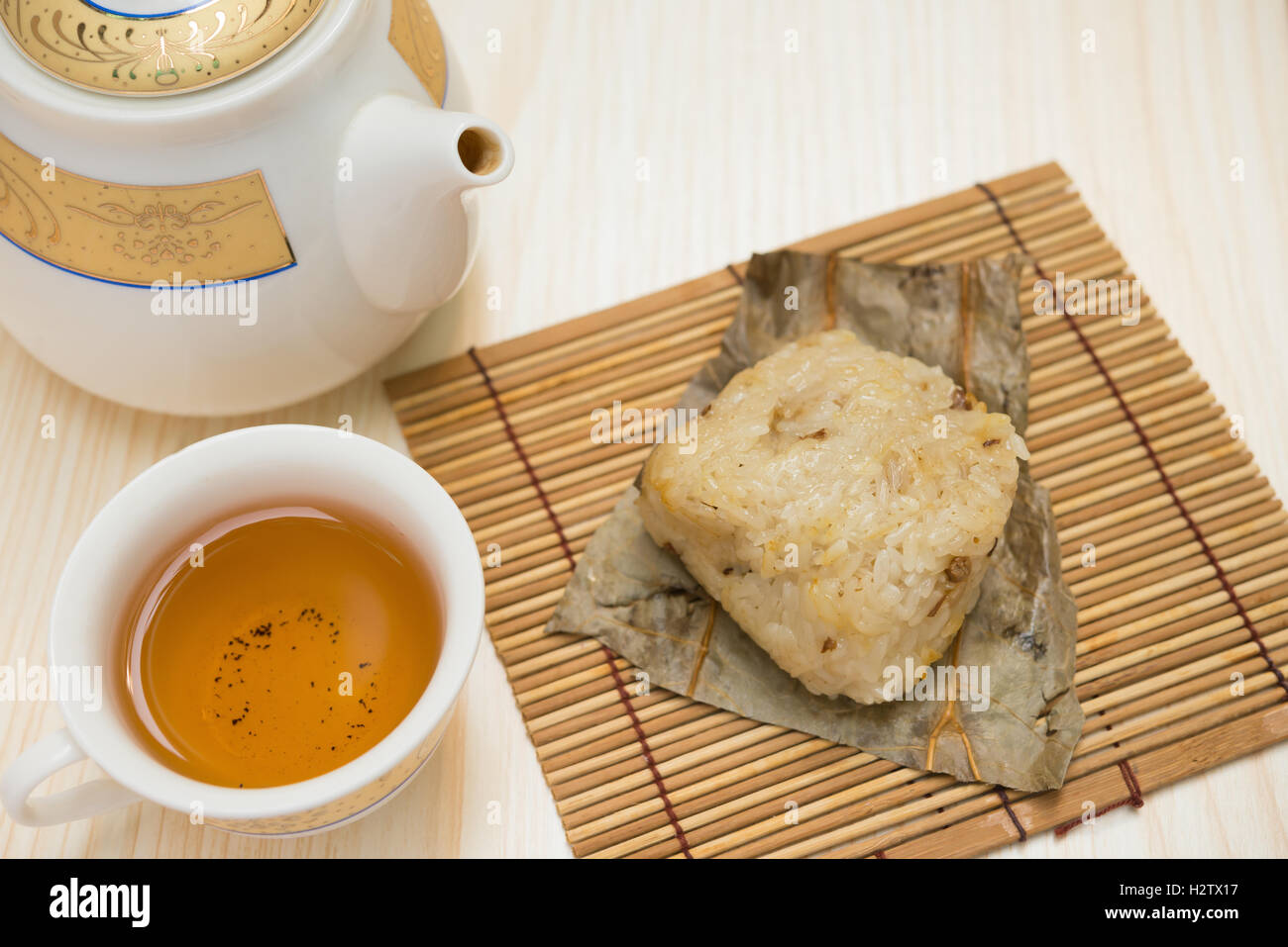 traditional Chinese glutinous rice dumpling with cup of tea and teapot ...