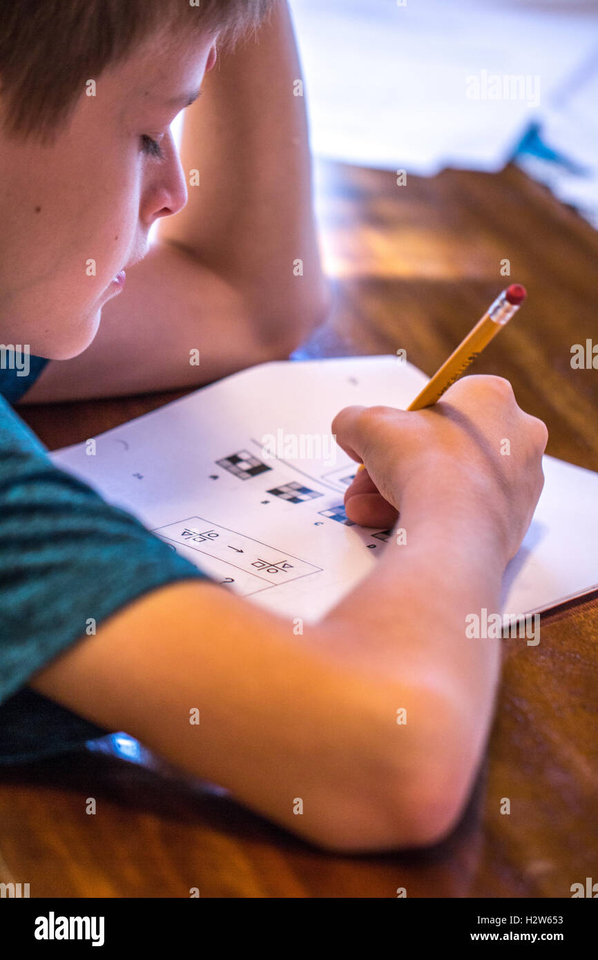 Boy doing math homework Stock Photo - Alamy