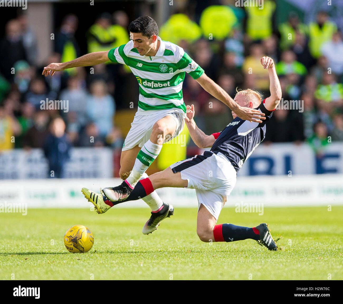 Celtic's Tom Rogic (left) and Dundee's Nicky Low compete for the ball ...