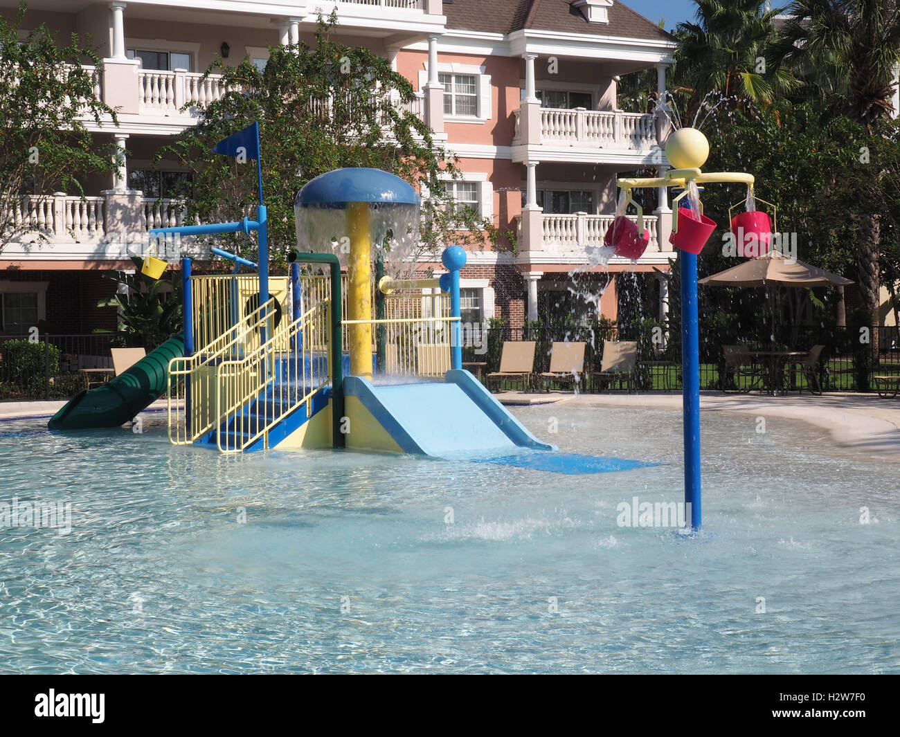 fun climbing and spray toys in an in-ground kid pool Stock Photo - Alamy