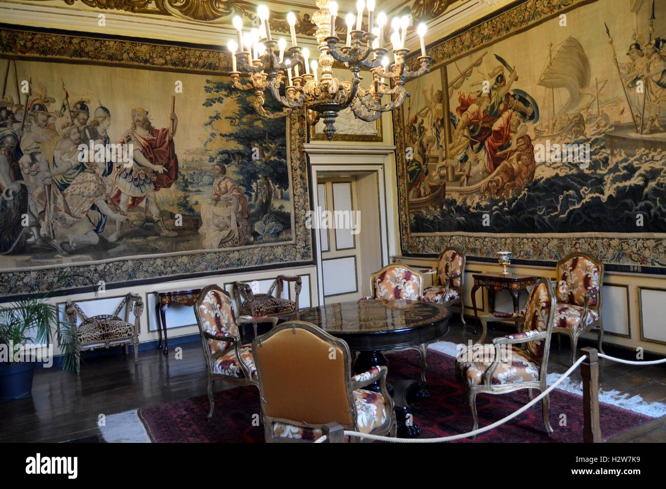 Room of castle with a table and chairs and two tapestries Stock Photo ...