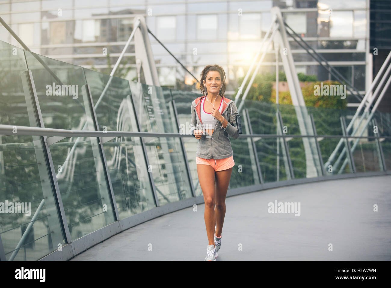 Young woman running in the city street Stock Photo - Alamy