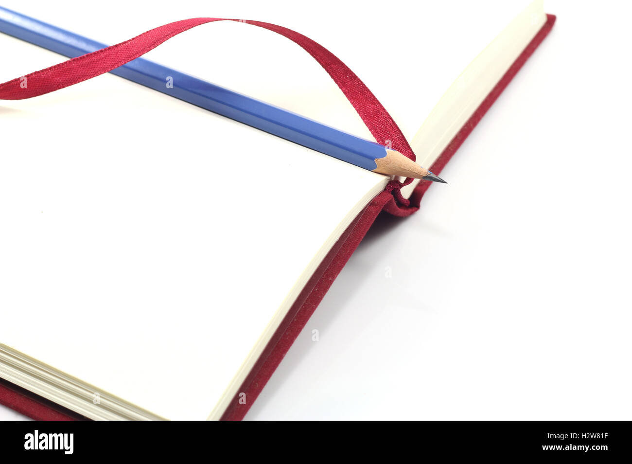 red notebook and blue pencil on white background Stock Photo - Alamy