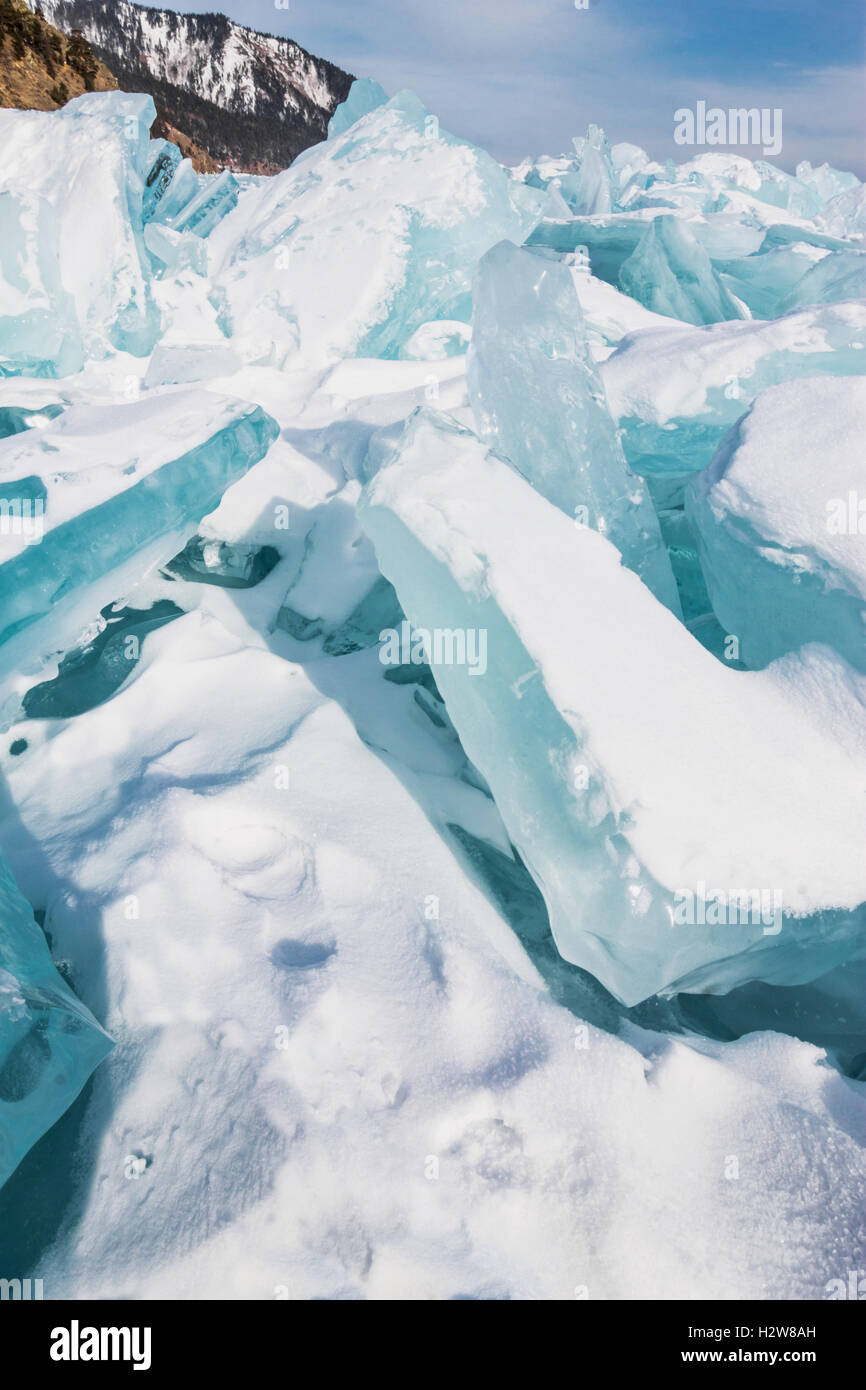 Ice chunks of blue ice is covered with snow on a sunny day Stock Photo ...