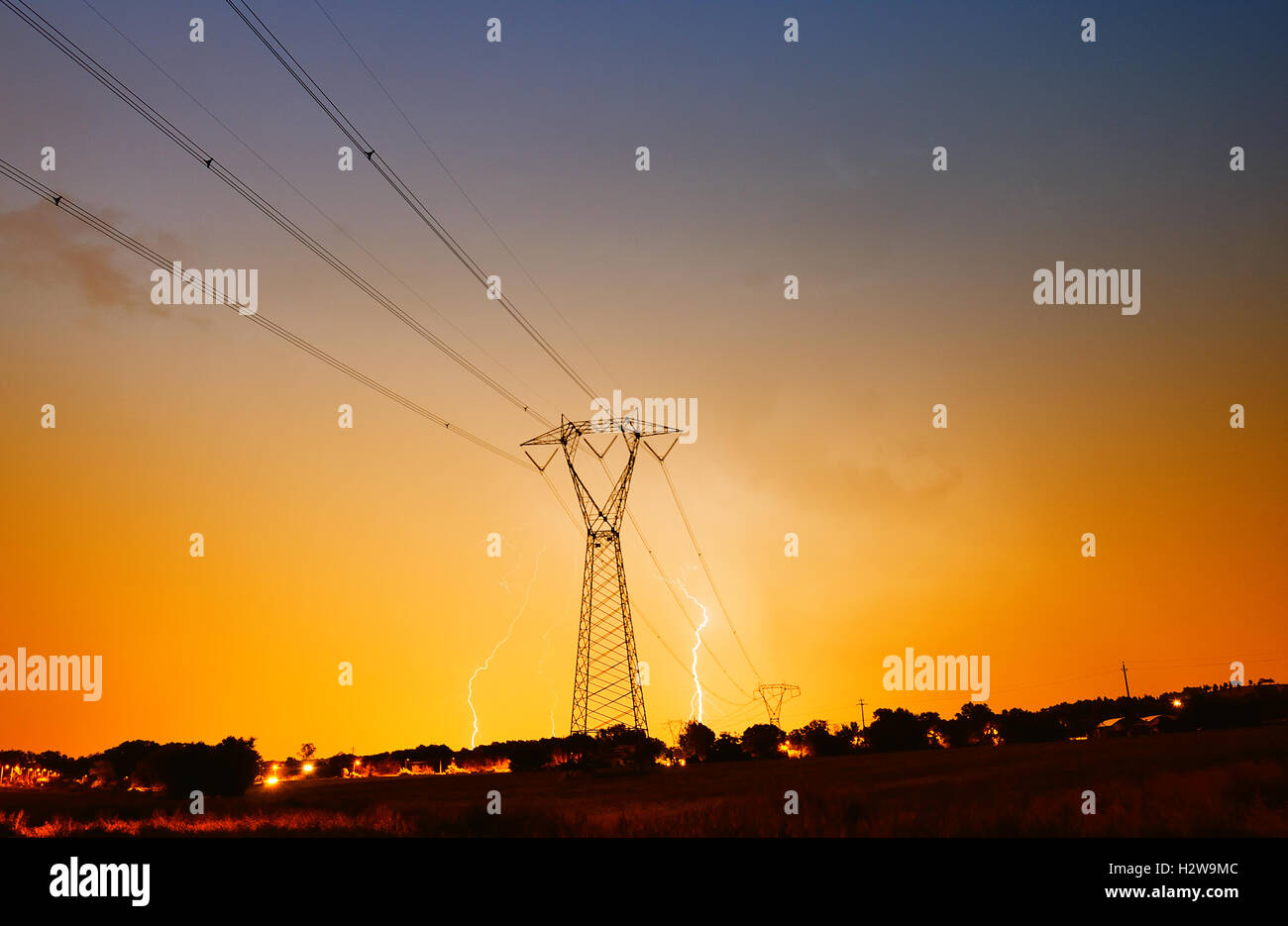 high voltage pylon with lightning in the sky in the night Stock Photo ...