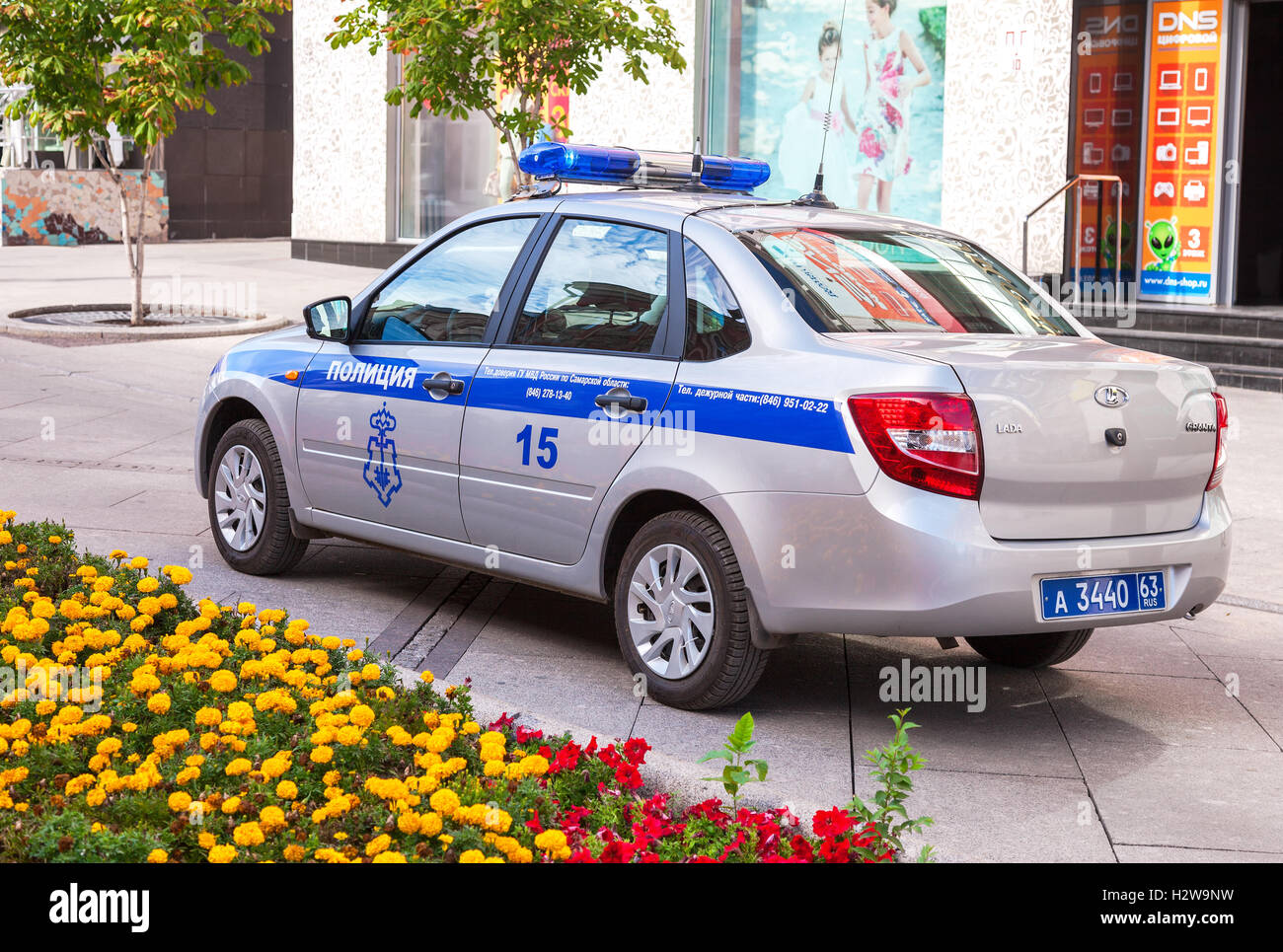 Russian police patrol vehicle parked on the city street in summer day ...