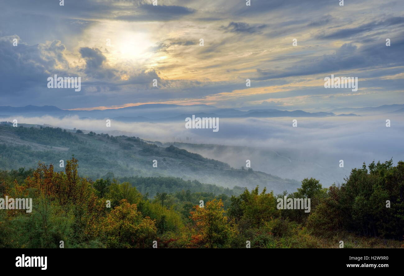 landscape of valley with mist at sunset Stock Photo - Alamy
