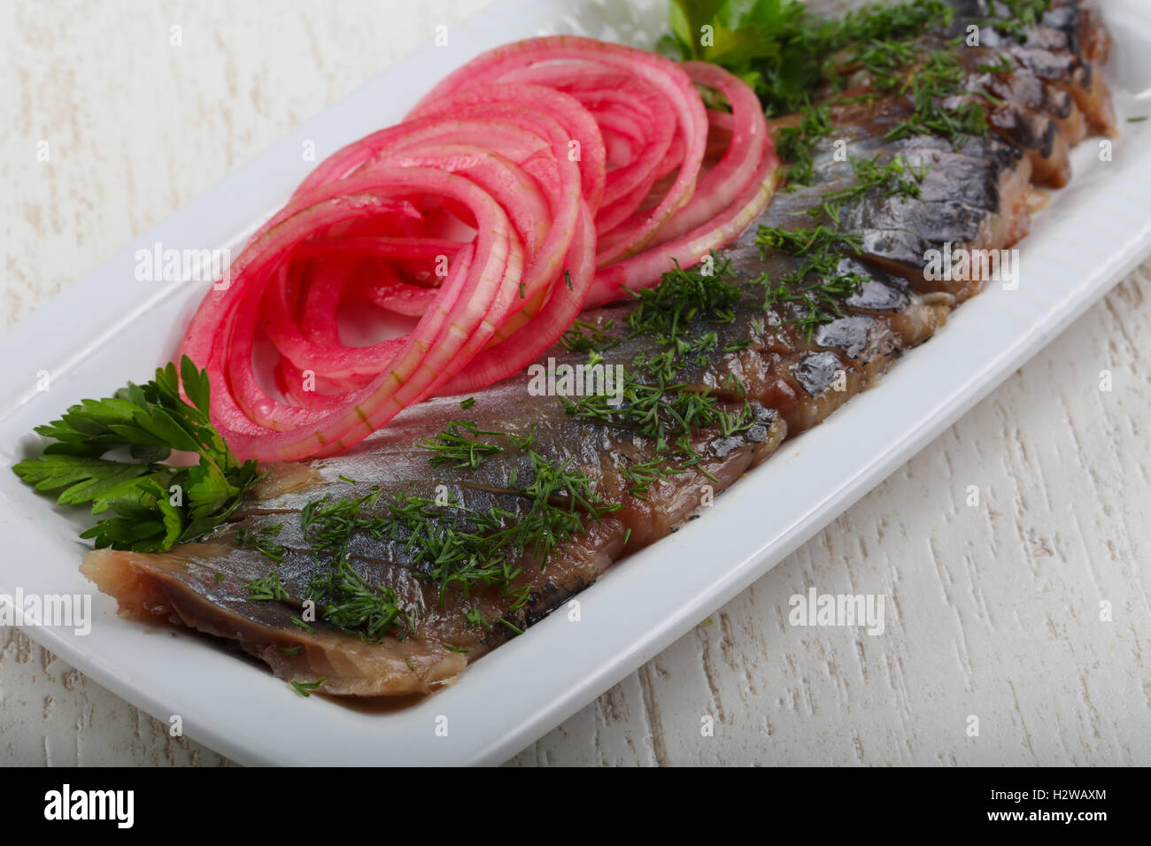 Herring fillet with pickled red onion and dill Stock Photo - Alamy