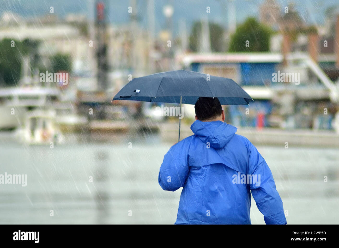 people with umbrella walking under the rain Stock Photo - Alamy
