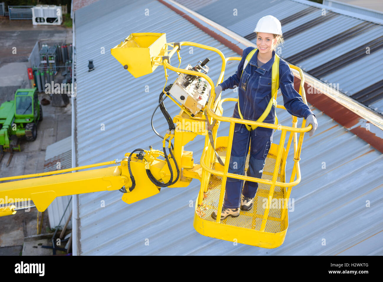 Portrait of woman in cherry picker bucket Stock Photo - Alamy