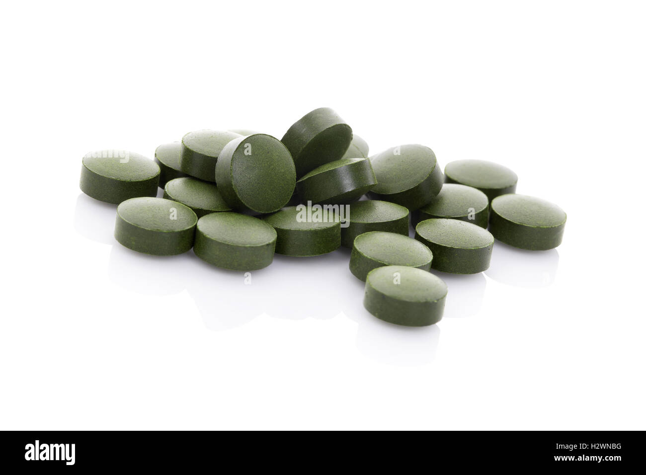 Green pills isolated on white background Stock Photo - Alamy