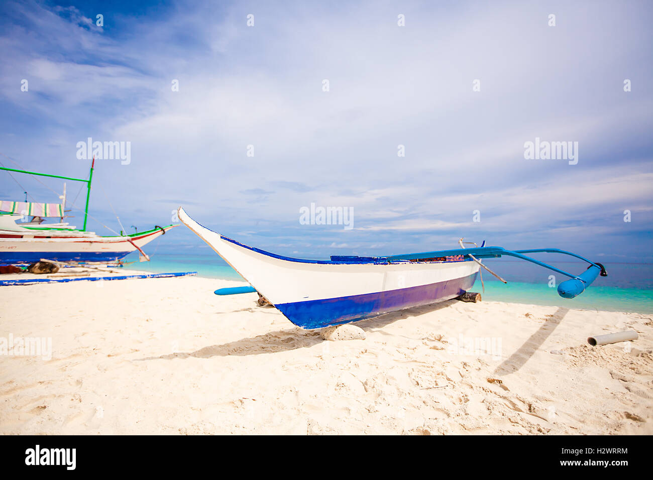 Small boat on the white beach in tropical island Stock Photo - Alamy