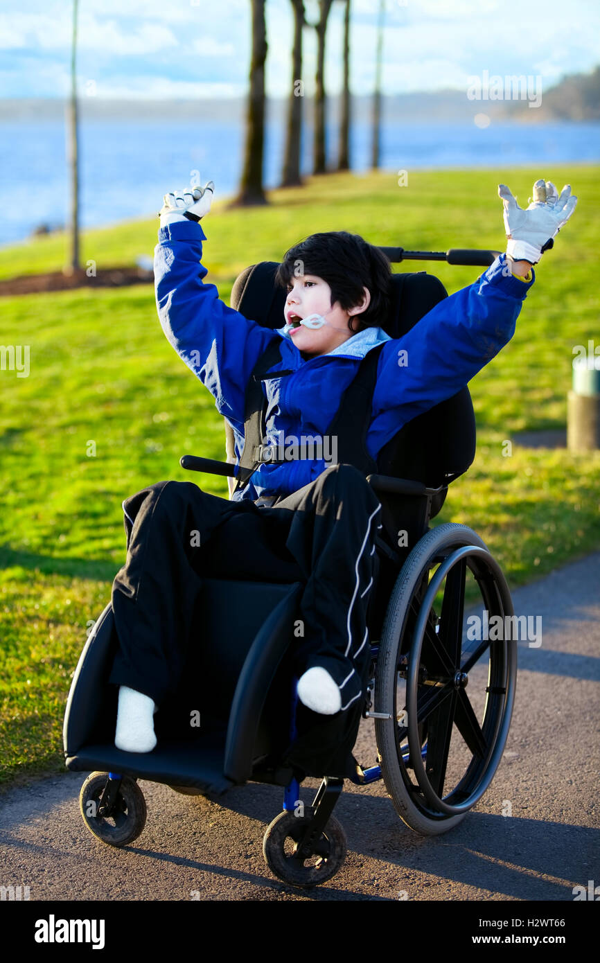Disabled boy in wheelchair enjoying day at park Stock Photo - Alamy