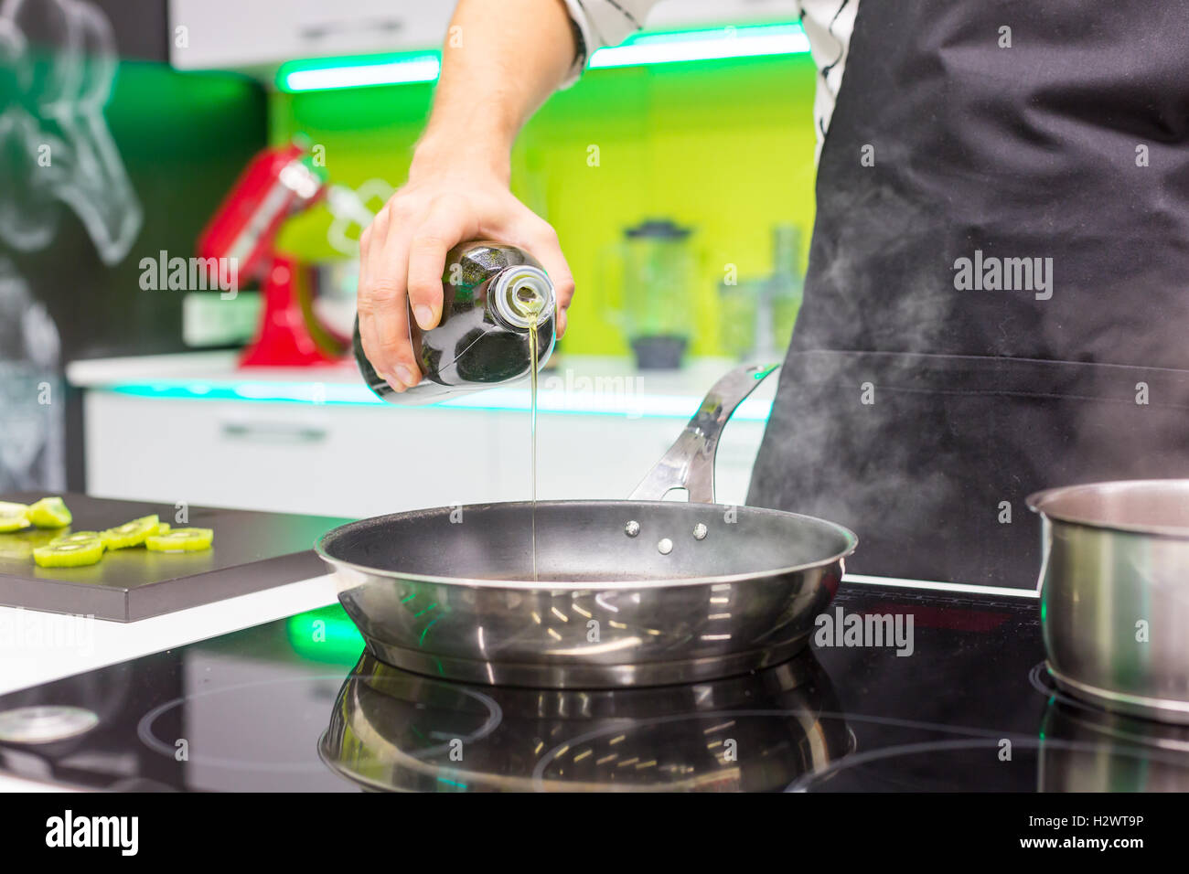 Man pouring oil Stock Photo - Alamy