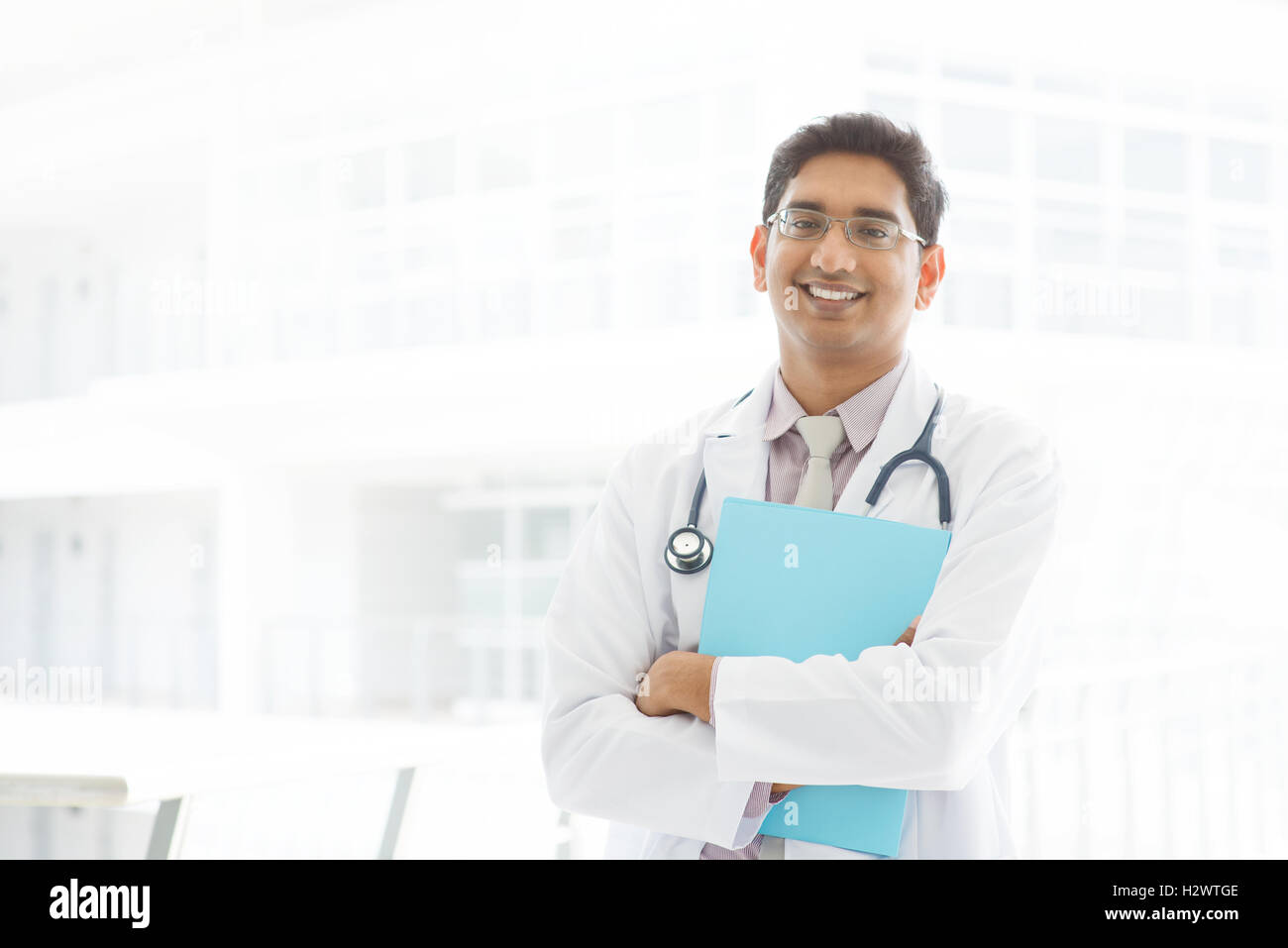 Asian Indian male medical doctor holding file folder Stock Photo - Alamy