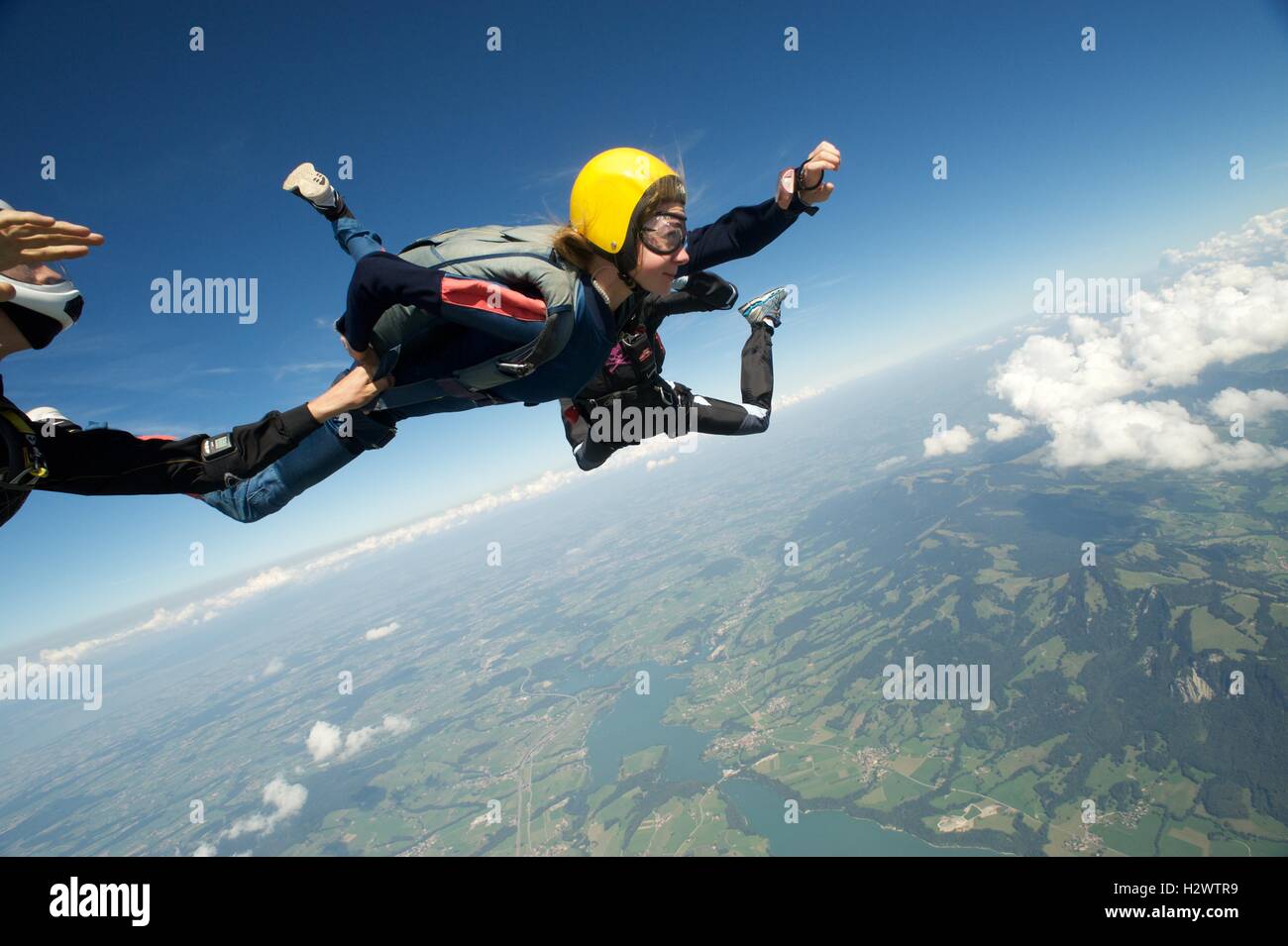 Woman on her first freefall jump with two instructors Stock Photo - Alamy