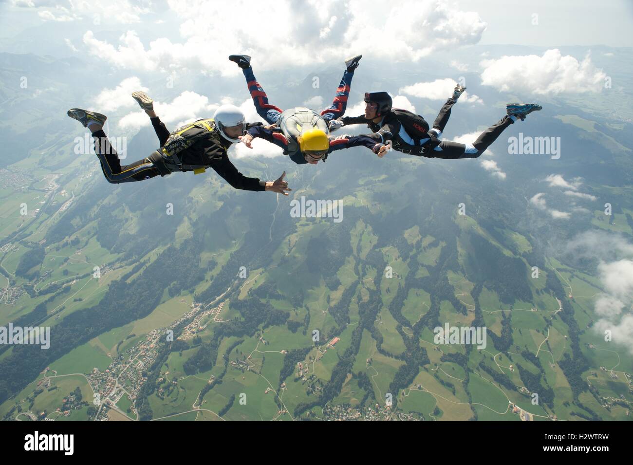 Woman on her first freefall jump with two instructors Stock Photo - Alamy