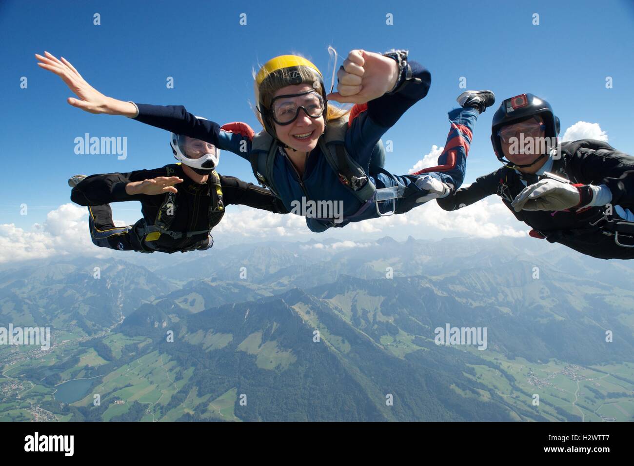 Woman on her first freefall jump with two instructors Stock Photo - Alamy
