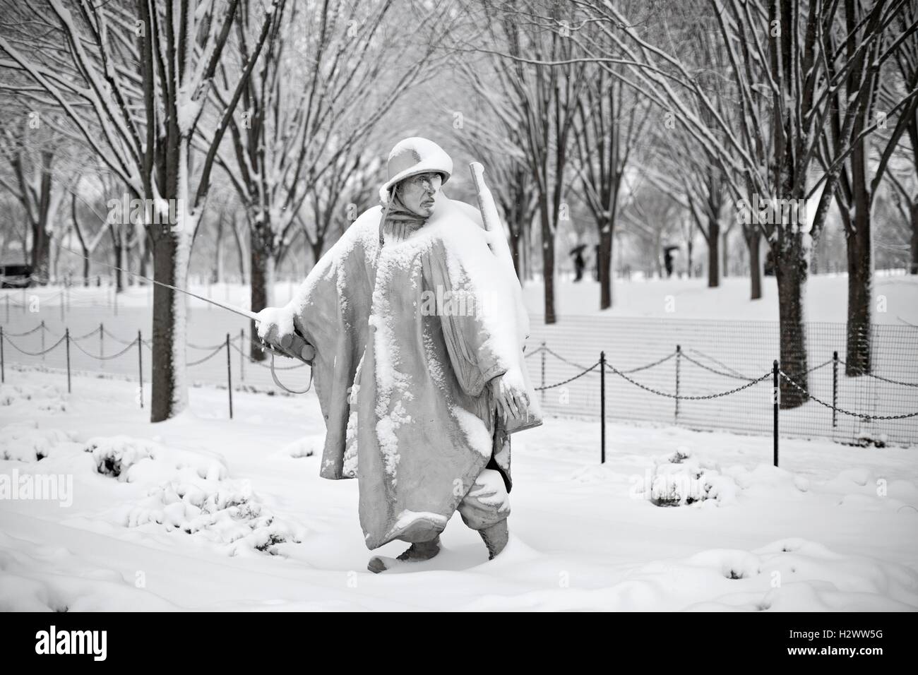 A snow-covered statue of a solider at the Korean War Memorial in ...