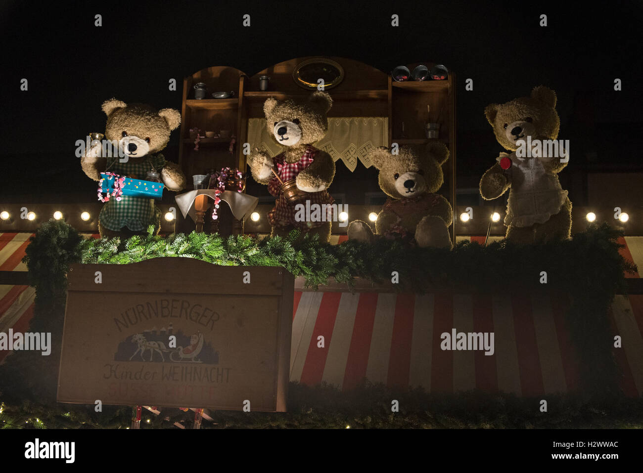 A family of teddy bears on display on top of one of the Christmas ...