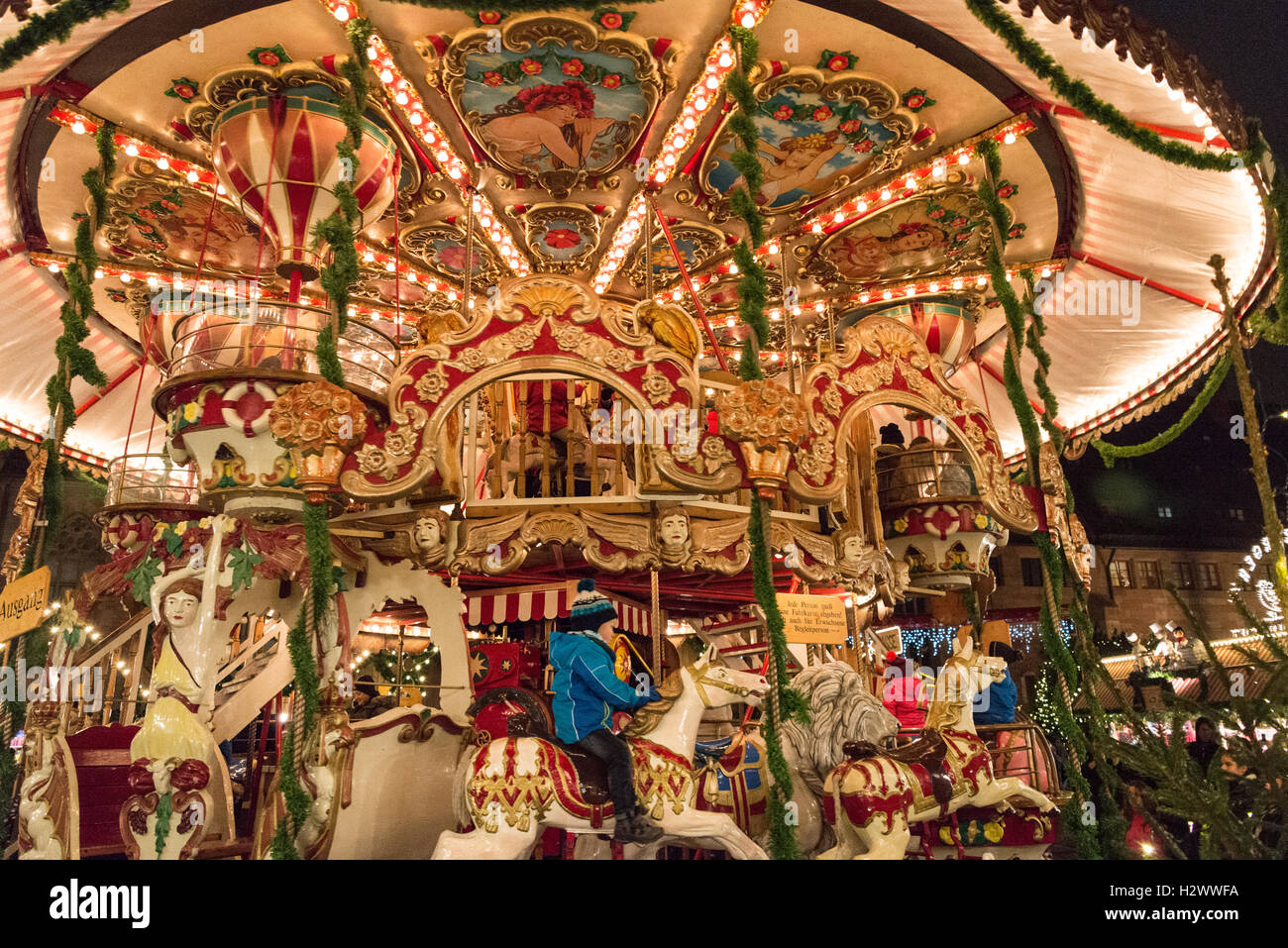 Children enjoying a ride on the biggest attraction, the Merry-go-round ...