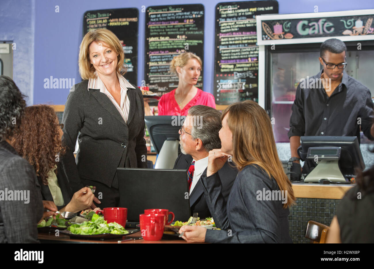 Happy Bistro Owner with Customers Stock Photo - Alamy