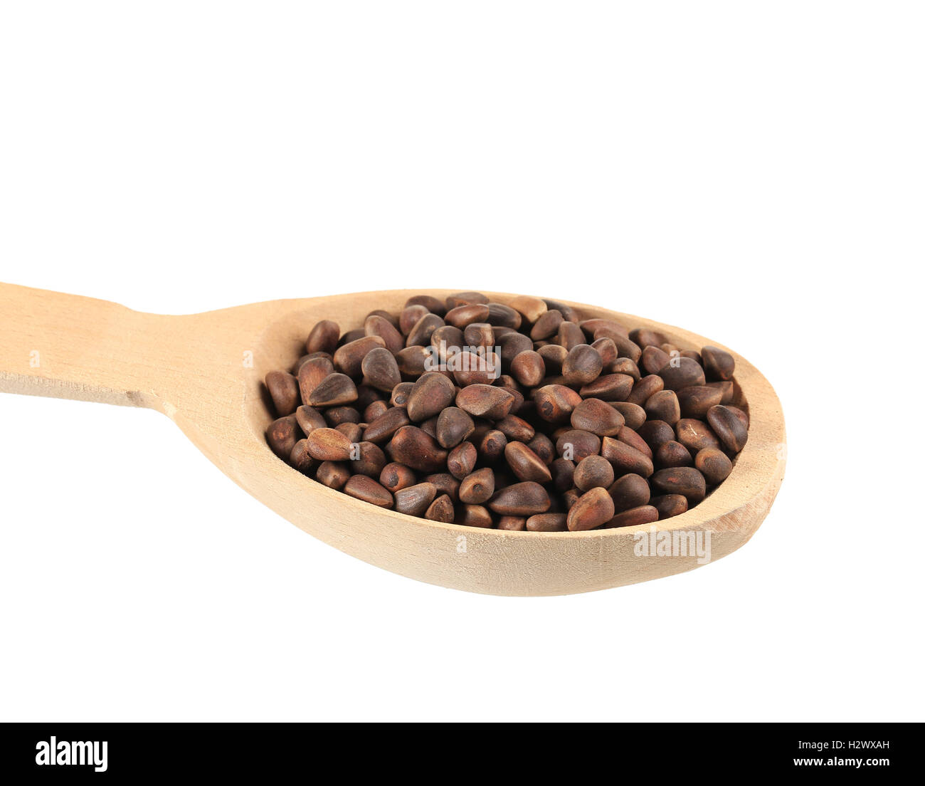 Wooden spoon full with pine nuts Stock Photo - Alamy