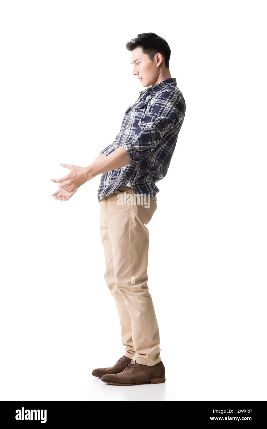 Asian young guy carry or take something Stock Photo - Alamy