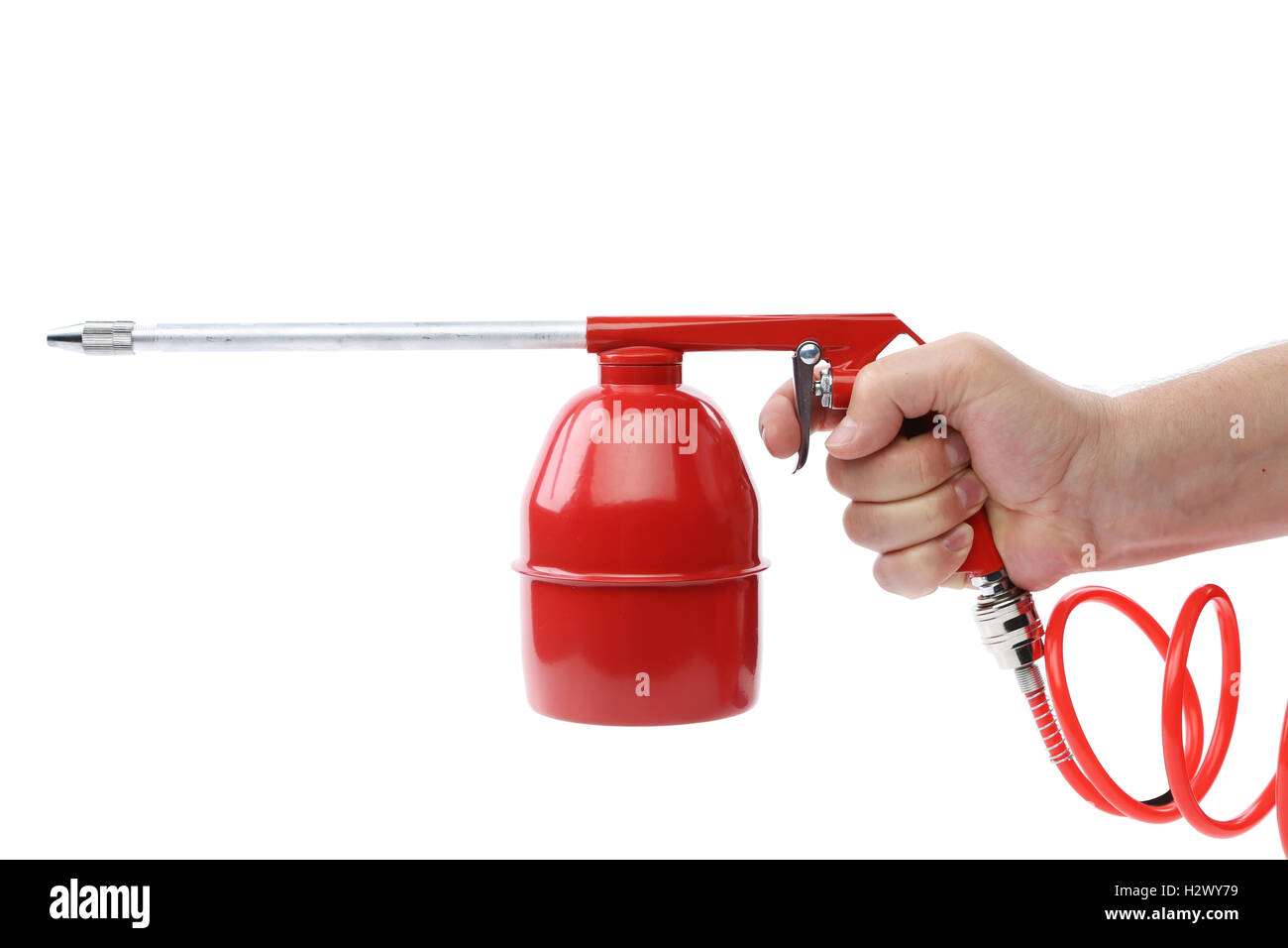 Hand holds spray gun with plastic spring Stock Photo - Alamy