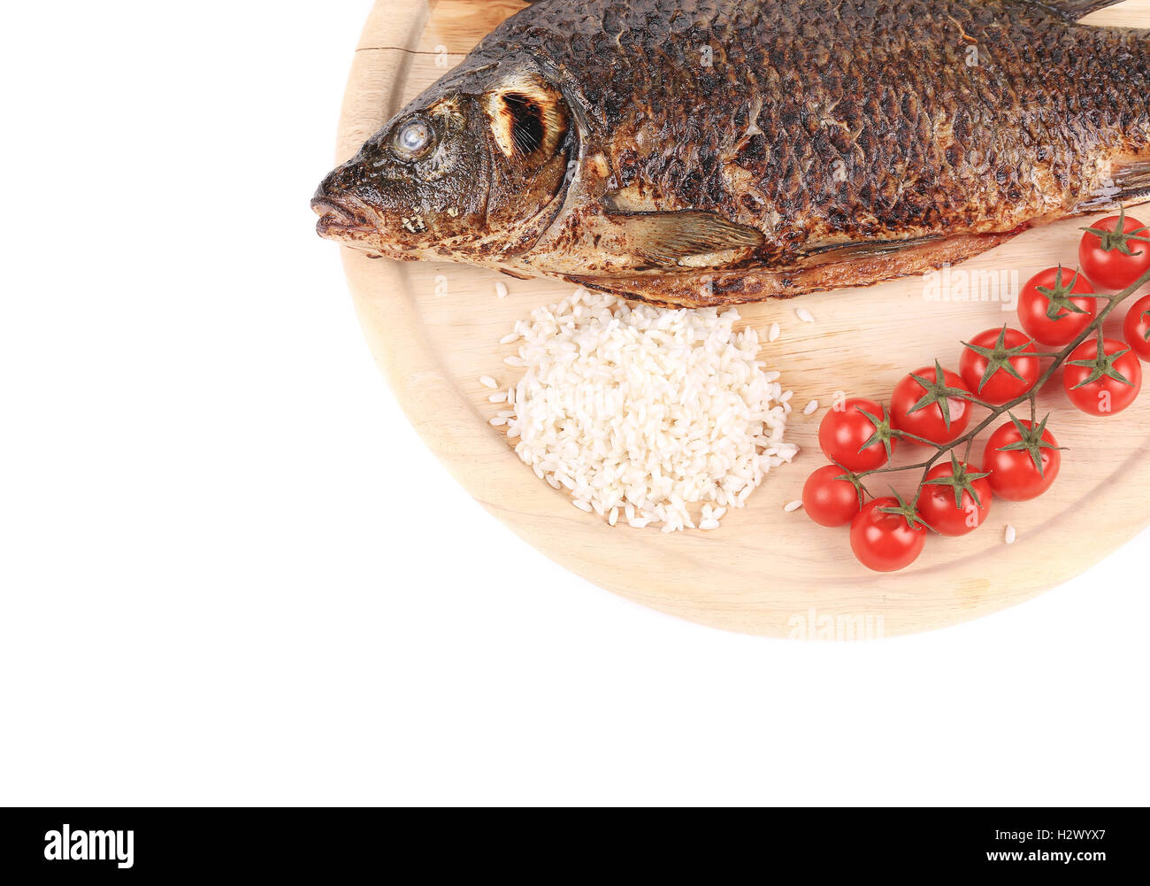 Grilled fish with rice and tomatoes Stock Photo - Alamy