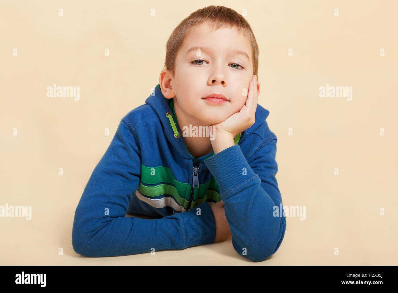 Boy looking into the camera and thinking Stock Photo - Alamy