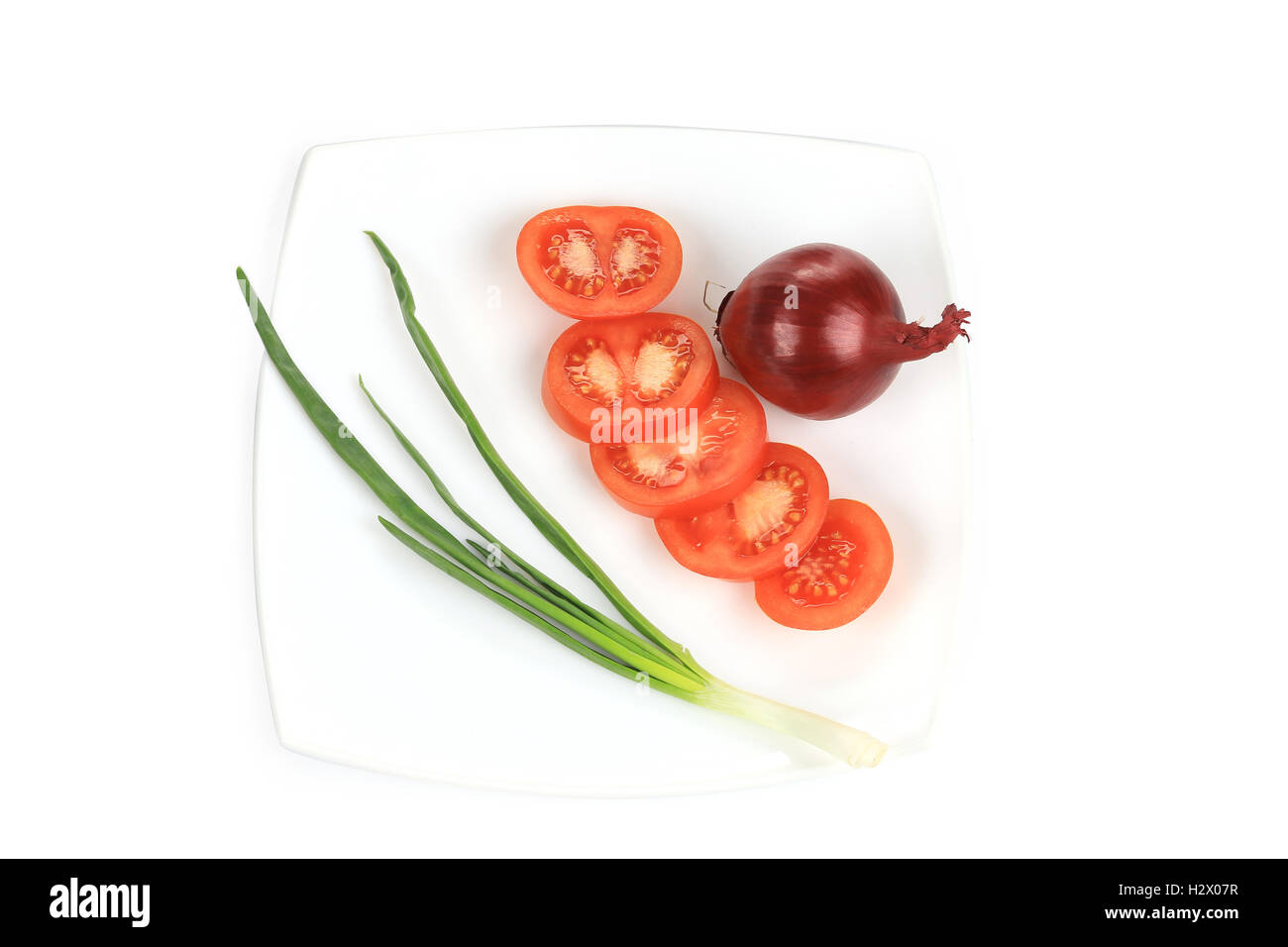 On cutting board sliced tomatoes Cut Out Stock Images & Pictures - Alamy