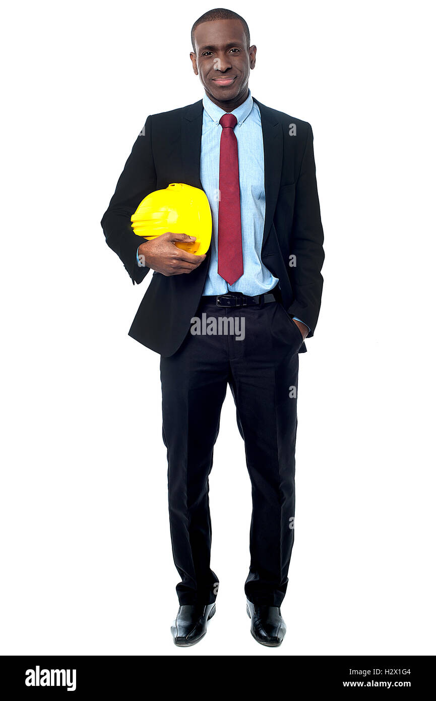 Handsome engineer holding yellow helmet Stock Photo - Alamy