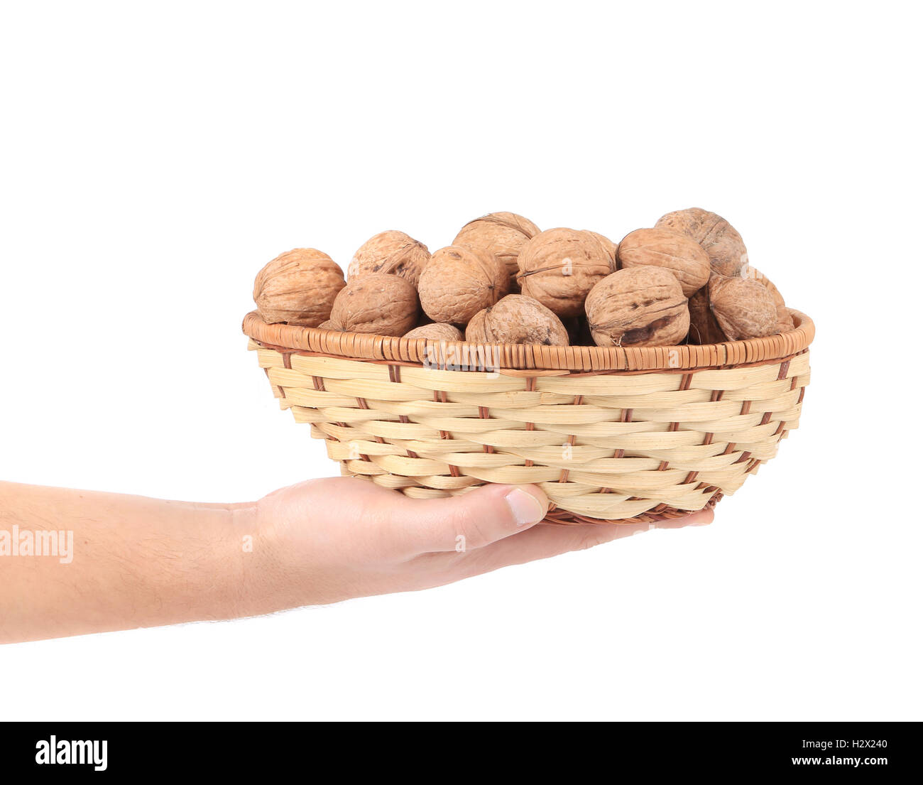 Hand holding basket of walnuts Stock Photo - Alamy