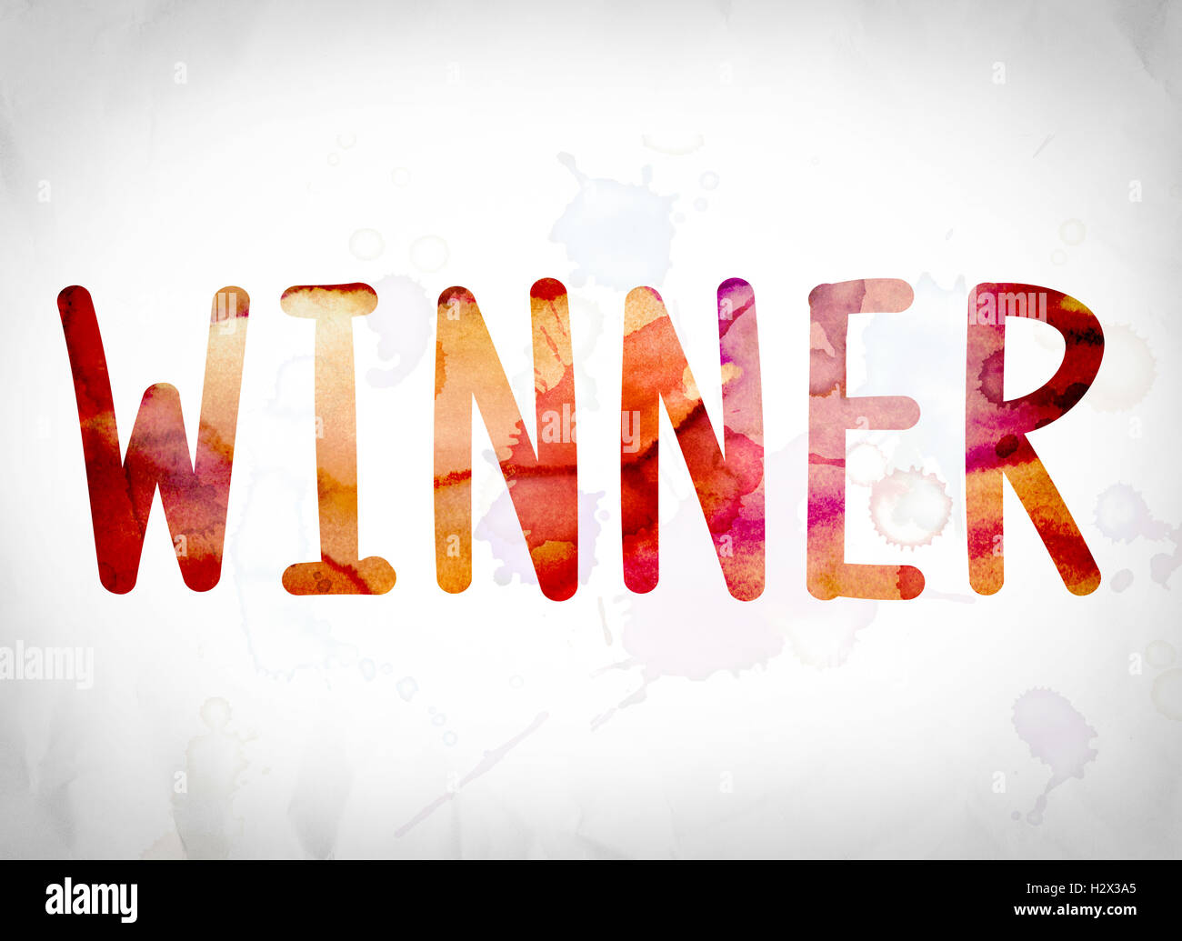 The word "Winner" written in watercolor washes over a white paper ...