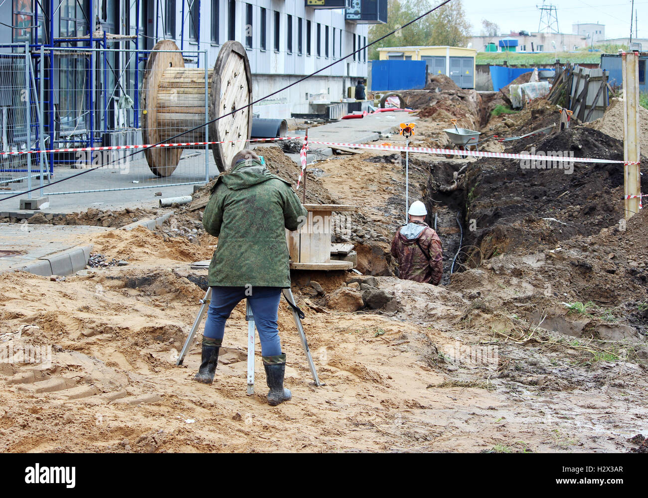 Two surveyor builder at a construction site near the apartment building ...
