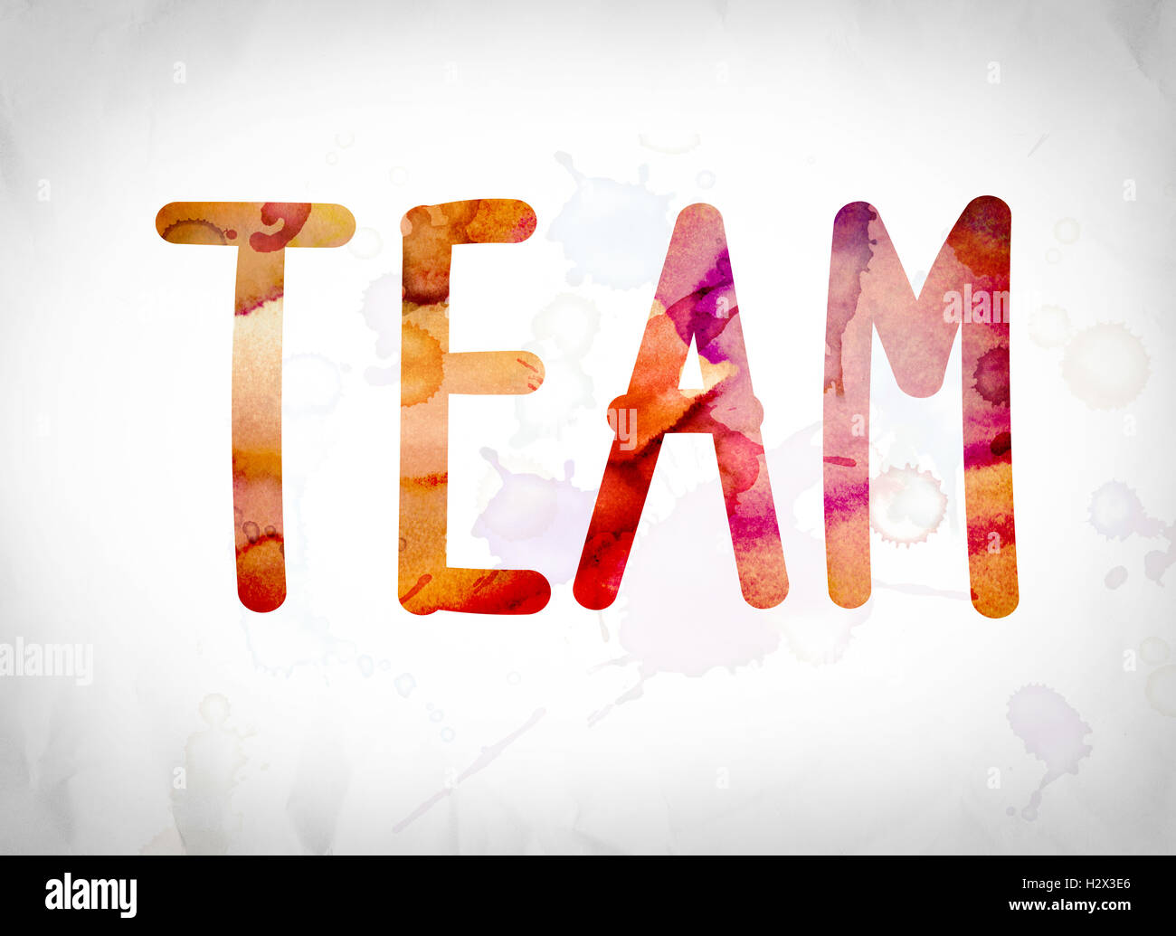 The word "Team" written in watercolor washes over a white paper ...