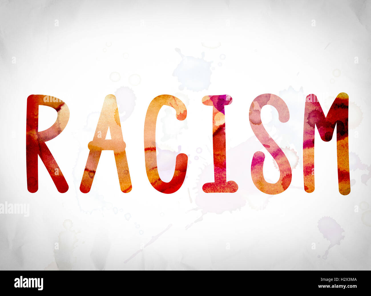 The word "Racism" written in watercolor washes over a white paper ...