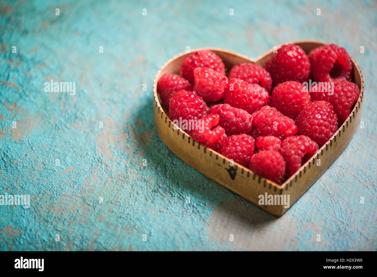 Raspberries in heart shape symbol, love for fruits and healthy living ...